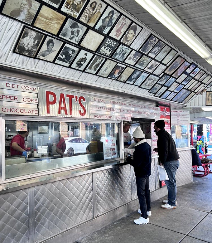 The wall of fame above the ordering window tells a story: celebrities, politicians, and everyday heroes all united by their quest for cheesesteak perfection.
