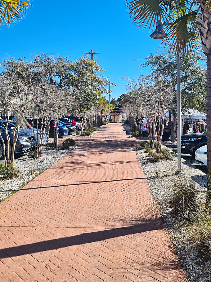 Brick pathways lined with native plants create a distinctly Southern shopping experience, inviting leisurely strolls between bargain destinations.