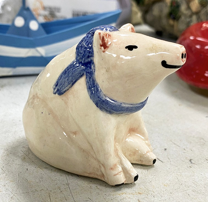 This ceramic polar bear figurine with its jaunty blue scarf has been waiting patiently for someone to appreciate its quirky charm. Art is truly subjective.