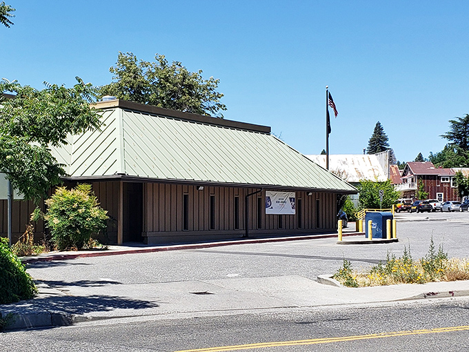 Even the practical buildings in Grass Valley wear a touch of character, with this simple structure serving as a community hub under the watchful gaze of pine trees.