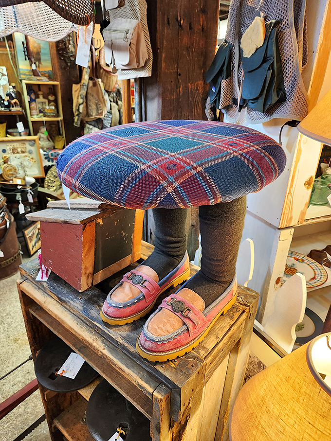 The footstool that fashion forgot! With plaid upholstery and mannequin legs sporting vintage loafers, this conversation piece screams "I dare you to put me in your living room."