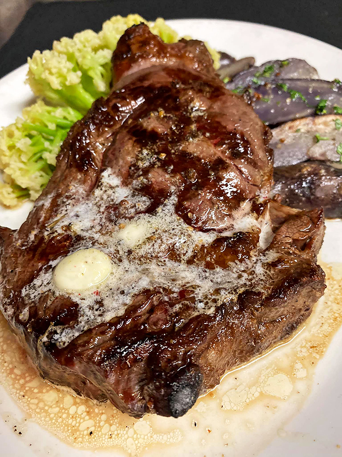 This ribeye isn't just a steak&mdash;it's a masterclass in meat, with a pat of butter slowly melting like a clock in a Salvador Dali painting.