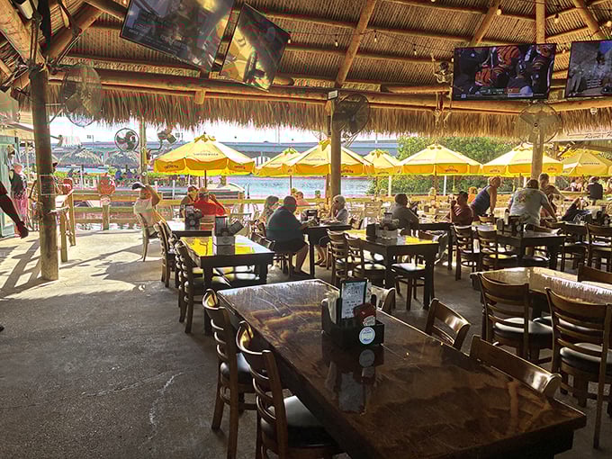 Yellow umbrellas dot the waterfront seating area where conversations flow as freely as the river, and nobody's checking their watch.