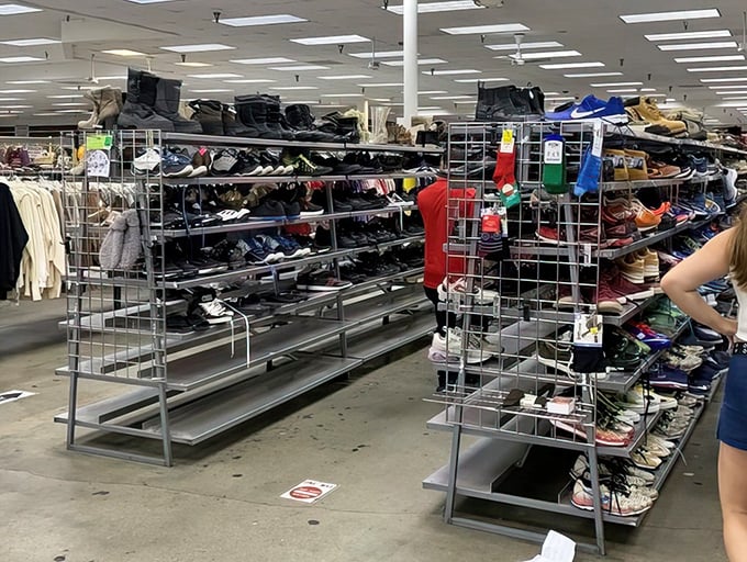 Metal shelving units packed with footwear stretch across the floor like a shoe lover's fever dream.