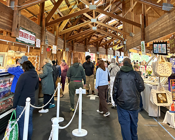 The cathedral of local commerce, where wooden beams frame the weekly pilgrimage of shoppers seeking connection to their food and those who grow it.
