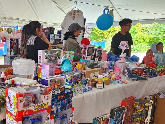 Shoppers huddle around tables, the social heart of the swap meet where strangers become temporary friends united by the thrill of discovery.
