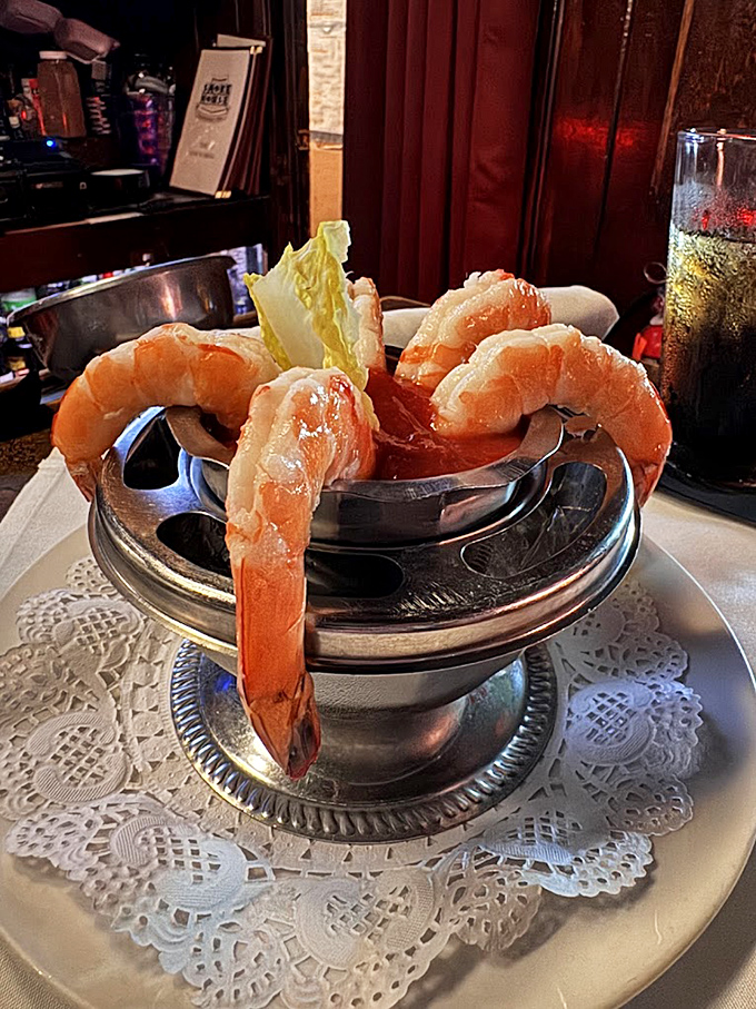 Shrimp cocktail served with the kind of old-world elegance that makes you sit up straighter, even as you're plotting to steal that last shrimp.