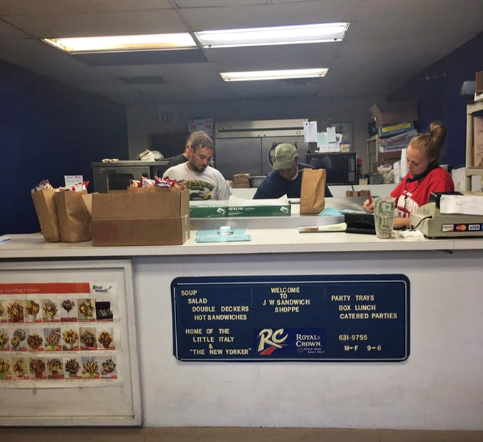 The sandwich artists at work, creating edible masterpieces with the focus of surgeons and the efficiency of a pit crew. No wasted movements, just practiced precision.