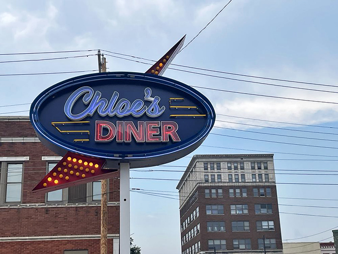 That classic neon sign beckoning like a lighthouse for hungry souls seeking comfort food salvation.