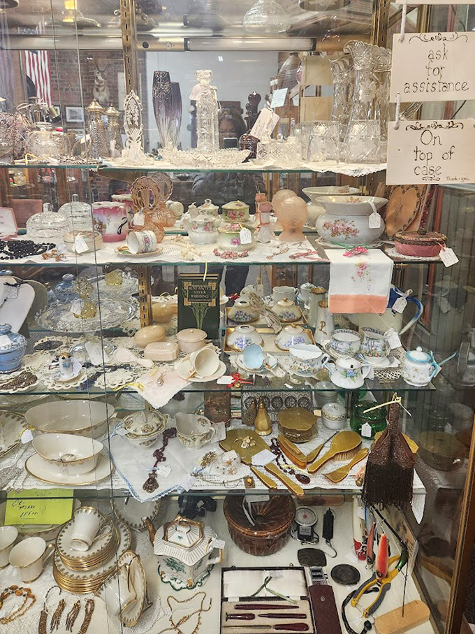 Behind glass, delicate teacups and porcelain treasures wait patiently for their next afternoon tea party, arranged like tiny soldiers of civility and good taste.