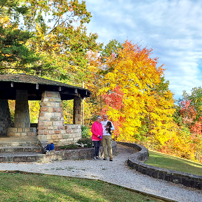 Fall's fiery backdrop transforms ordinary moments into frameable memories. These visitors found the perfect seasonal selfie spot&mdash;no Instagram influencer could design it better. 
