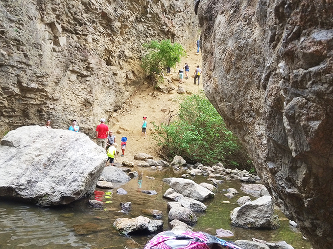 The secret's getting out! Visitors explore the creek bed, finding their own perfect spots to enjoy this natural playground.