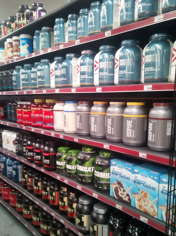 Protein powders and supplements lined up like soldiers ready for your fitness battle. The bodybuilder's candy store, minus the guilt and plus the gains.