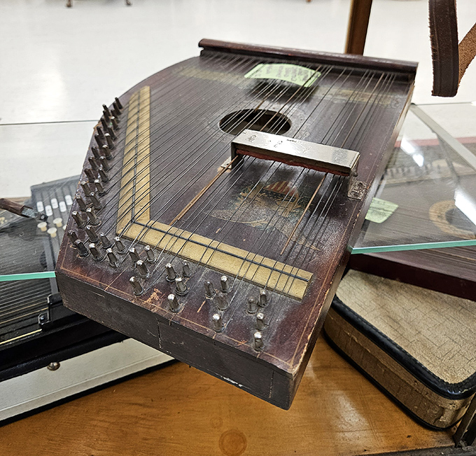 A zither waiting patiently for someone to appreciate its strings and the craftsmanship of a bygone era.