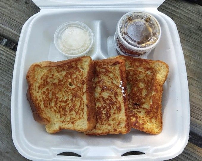 Three slices of French toast so perfectly golden they could win a beauty pageant in the carbohydrate category.