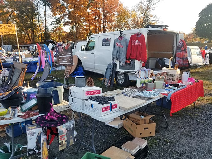 Autumn leaves frame the scene as vendors transform their vans into pop-up shops &ndash; Phillies gear hanging like ripe fruit.