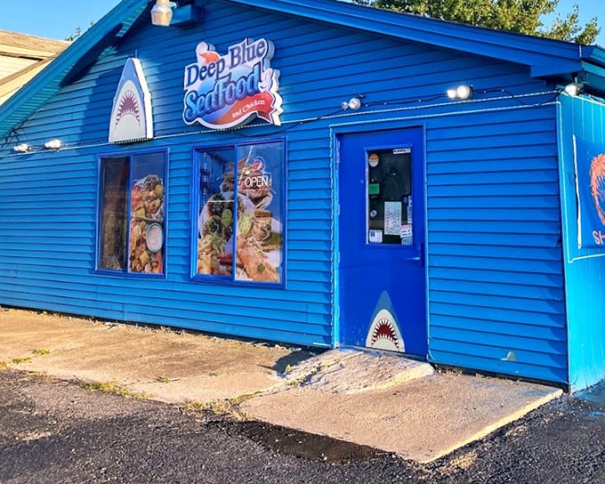 Deep Blue Seafood's vibrant blue exterior stands out like a sapphire in Portage. Small building, big flavors!