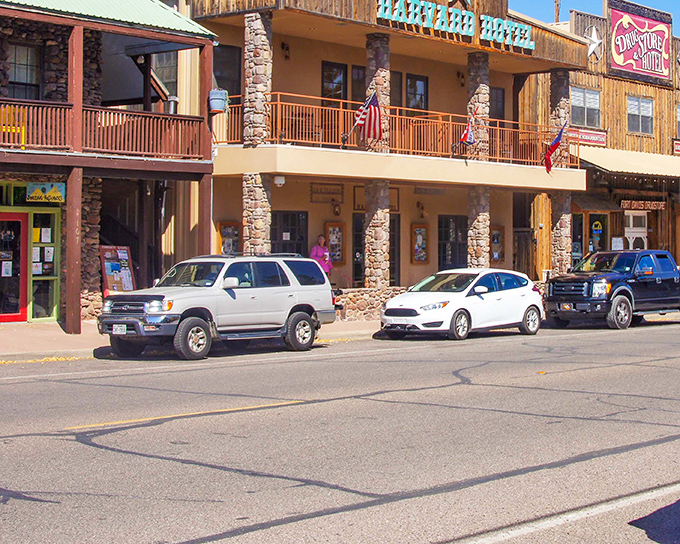 Fort Davis' rustic charm shines through in these stone-and-wood buildings, where American flags flutter proudly against the mountain backdrop.