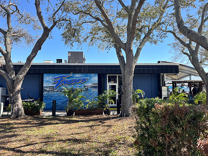 Fresco's blue building houses sophisticated waterfront dining where grouper sandwiches meet culinary artistry perfectly.