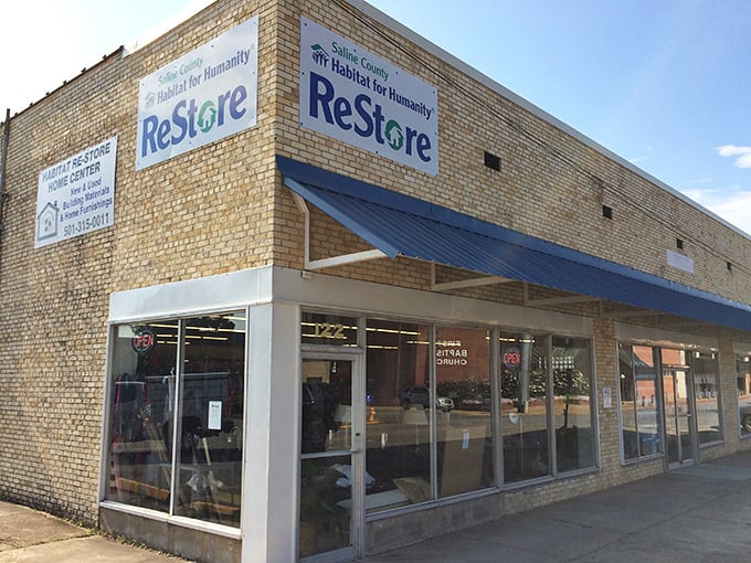 The corner location and blue awning mark this Habitat ReStore as downtown Benton's home improvement headquarters.