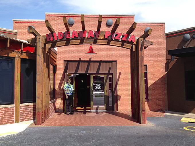 Hideaway Pizza's glowing sign serves as a beacon for hungry travelers. This Tulsa institution has been quietly perfecting pizza for decades.