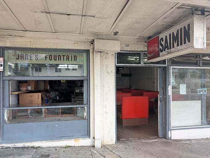 A time capsule of diner culture with classic window signage that promises fountain treats and breakfast delights.