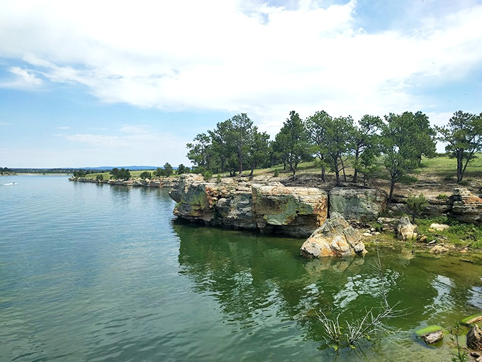 Calm reservoir waters reflect endless sky, creating a mirror effect that doubles your scenic value.