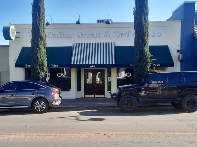 Tall cypress trees frame Nic's Italian Steak & Crab House, where Mediterranean meets mesquite in delicious harmony.