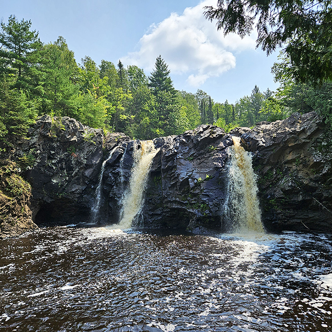 Twin cascades that look like they belong on a postcard&mdash;Big Manitou Falls at Pattison State Park doesn't just flow, it performs!