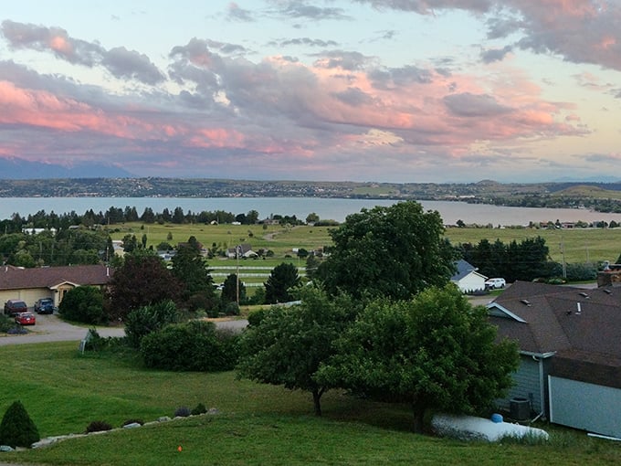 Polson overlooks Flathead Lake's vast expanse, where cherry orchards and mountain views create picture-perfect Montana living.