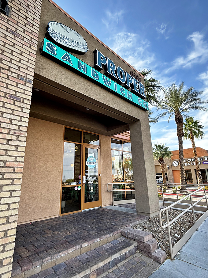 Proper Sandwich Company's entrance &ndash; where that teal signage promises sandwiches with architectural precision.