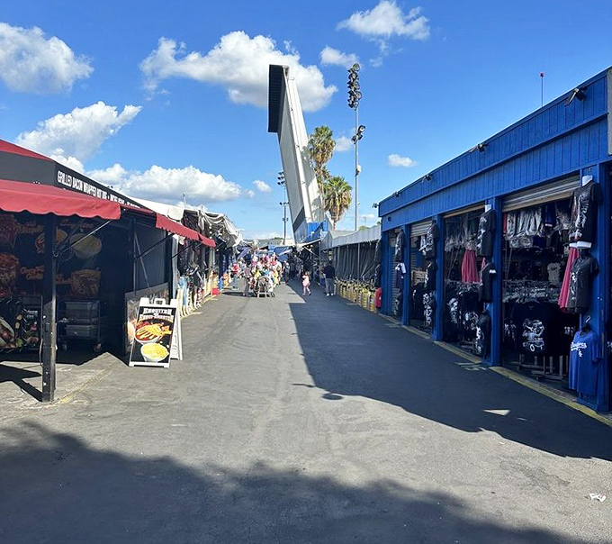 Permanent stalls line this bargain boulevard at Santa Fe Springs, where food signs tempt shoppers between treasure hunts.