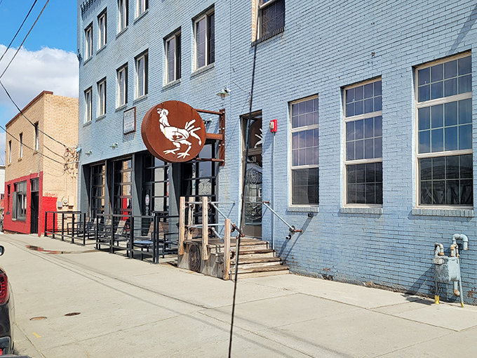 The Starving Rooster's playful logo and blue brick charm promise comfort food that satisfies every craving. 