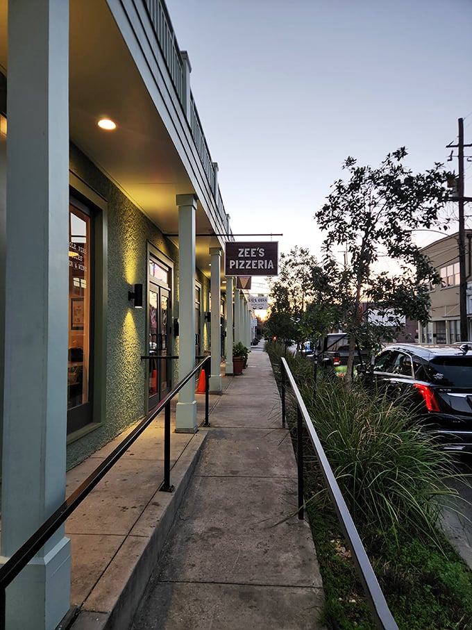 Zee's subtle sidewalk sign marks the spot where pizza dreams come true in New Orleans.