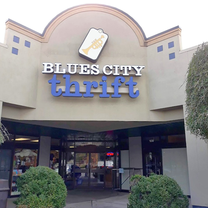 The distinctive trumpet tag logo of Blues City Thrift stands out against their clean storefront, promising Memphis music style and amazing deals.