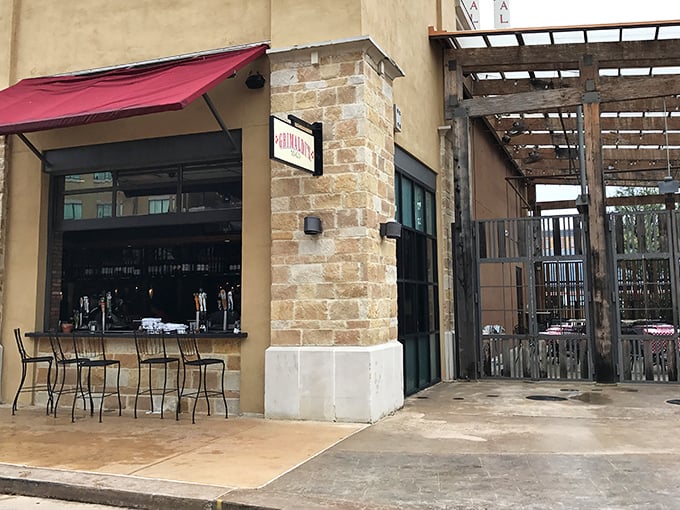 The covered patio and warm lighting create the perfect atmosphere for lingering over exceptional pizza.