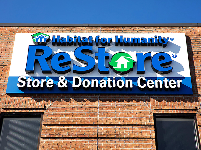 Logo with a mission! Habitat's ReStore sign pops against brick like a superhero emblem for those fighting high prices one donation at a time.