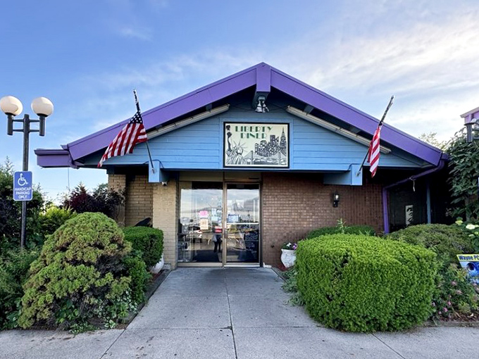 The welcoming entrance to Liberty Diner promises comfort food and community. Those flags aren't just decoration – they're a breakfast philosophy.