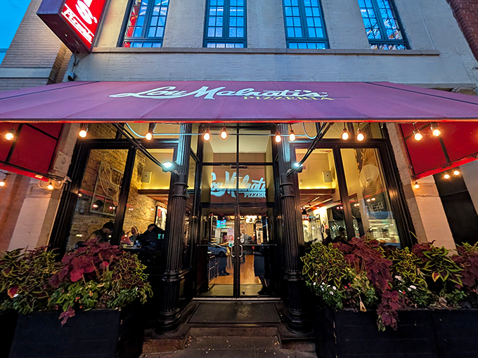 The elegant entrance with lush planters hints at the care that goes into every buttery-crusted masterpiece.