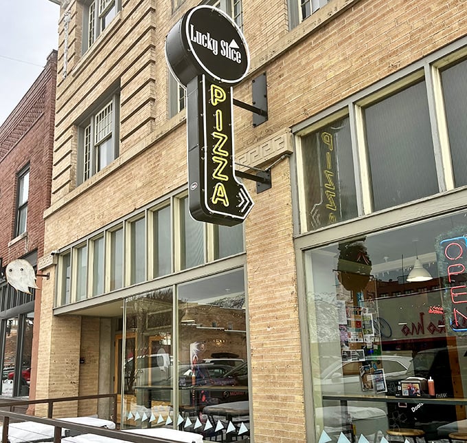 That vertical "PIZZA" sign points the way to Lucky Slice heaven. Follow it like the North Star of your hunger.