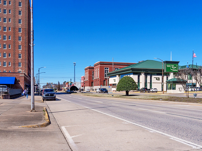 A tall brick hotel stands sentinel over McAlester's main street, where the green-roofed bank building adds a splash of color to this quintessential Oklahoma townscape.