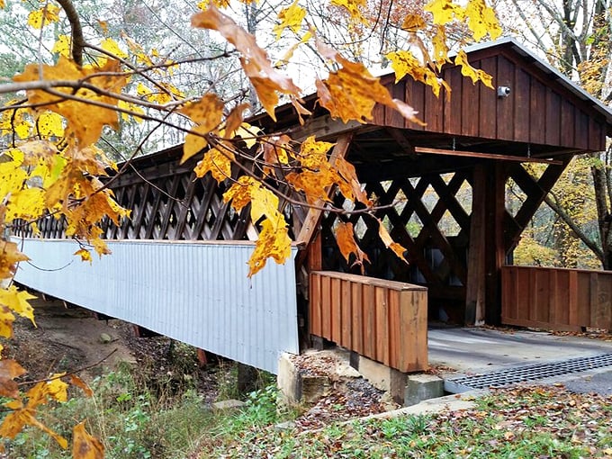 Covered bridge spans time itself, connecting past and present with weathered wood and timeless charm.