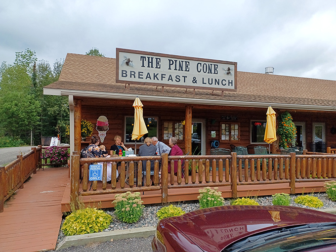 Flowers bloom around The Pine Cone's welcoming porch, where diners enjoy sandwiches with a side of Minnesota's natural beauty.