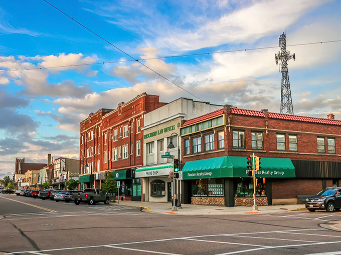 Golden hour bathes Rhinelander's downtown in warm light, where green awnings welcome retirees seeking small-town charm without emptying their savings accounts.