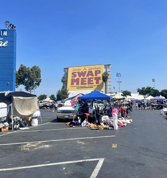 Santa Fe Springs Swap Meet's yellow banner announces a bargain hunter's playground against a perfect blue sky.