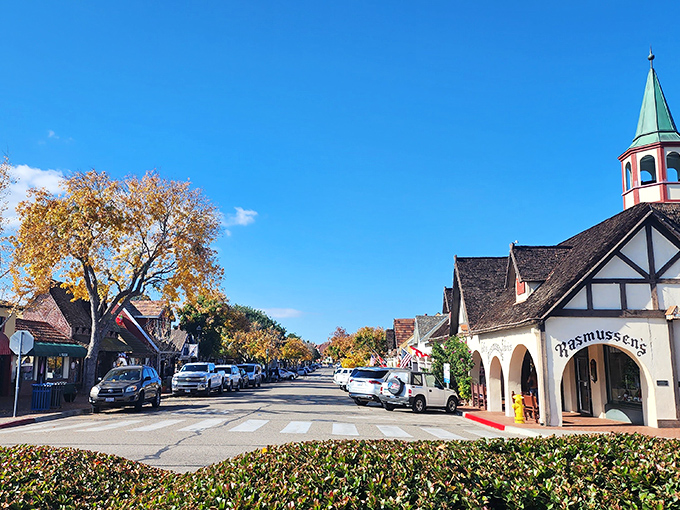 Charming storefronts and storybook rooftops line this sunny street, where every corner feels like it belongs in a fairytale village.