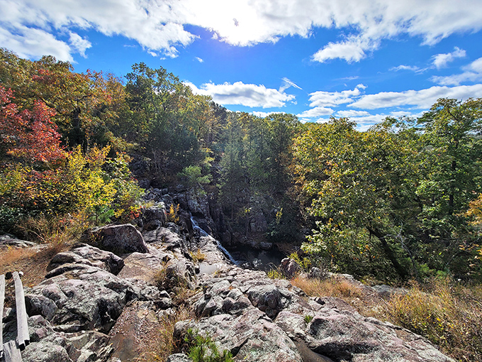 Fall colors transform Taum Sauk Mountain into nature's own fireworks display. Those reds and golds pop against the clear autumn sky.