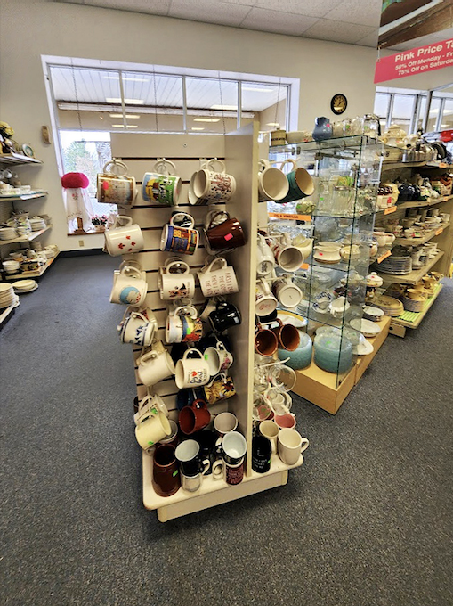 The mug wall&mdash;where coffee vessels of past decades gather to find new homes. One person's forgotten Disney souvenir is another's morning joy.