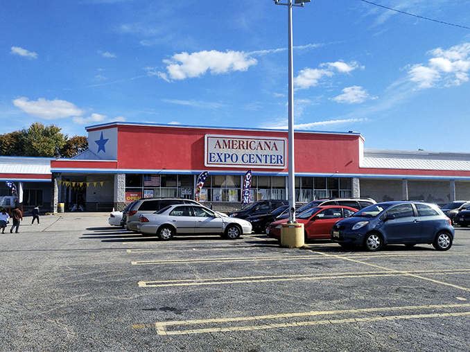 The patriotic red facade of Americana Expo Center stands like a beacon for bargain hunters, promising treasures within its unassuming walls.