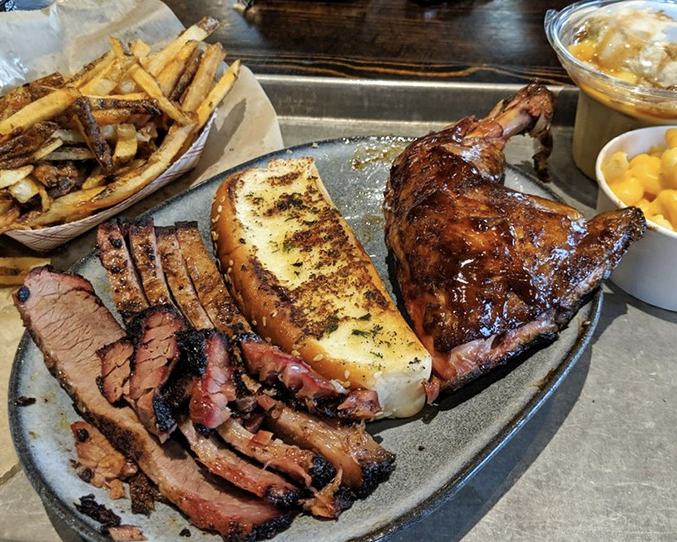 Meat candy for grown-ups: brisket with that coveted smoke ring alongside chicken that's clearly been on speaking terms with fire.